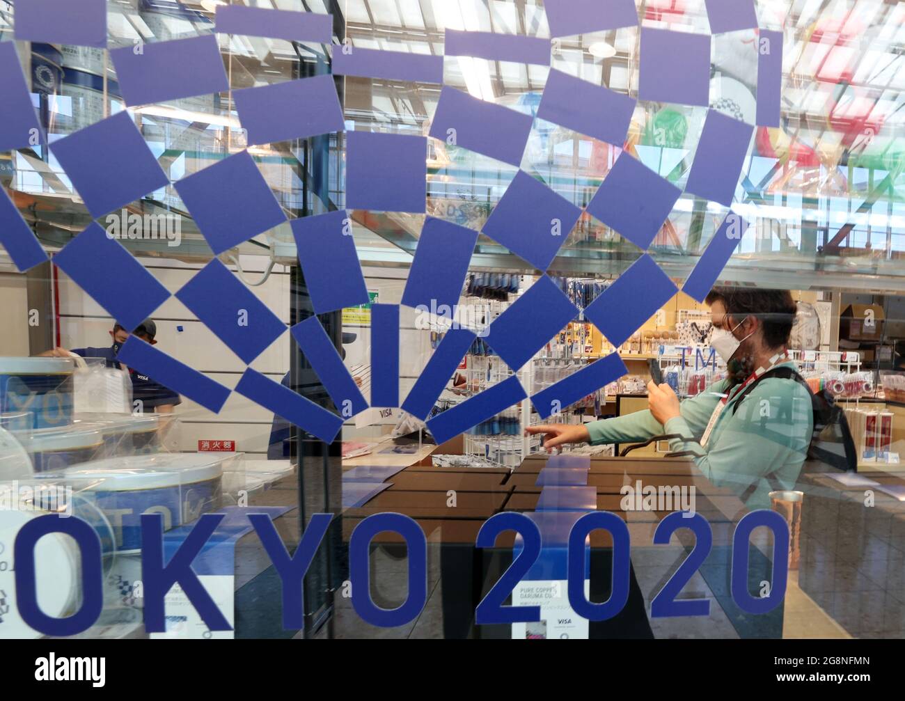 Tokyo, Japan. 22nd July, 2021. A journalist shops at a souvenir store ...