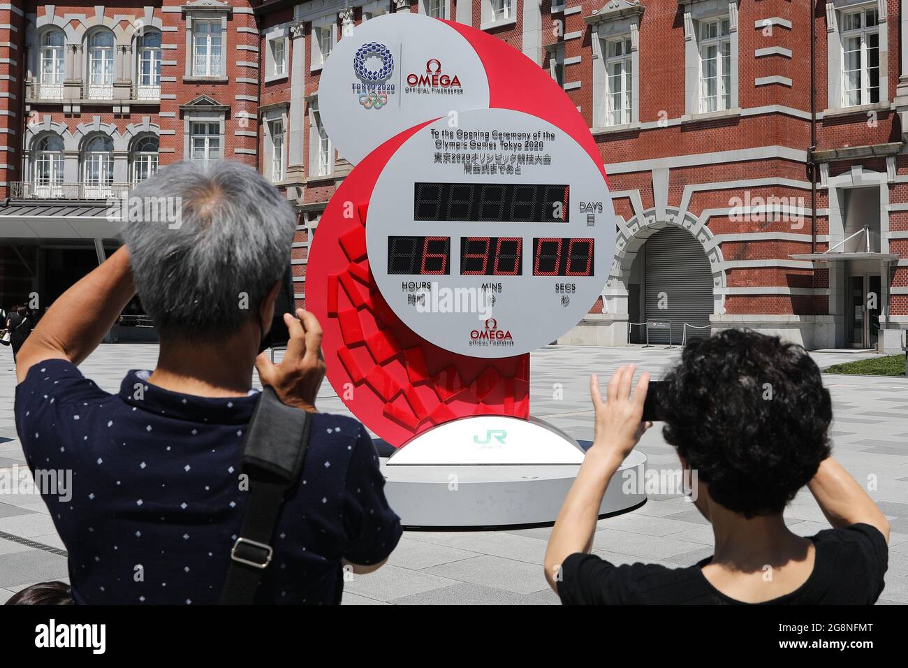 Tokyo, Japan. 22nd July, 2021. People take photos of a countdown clock ...