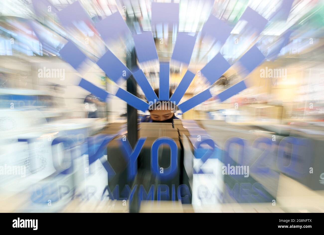Tokyo, Japan. 22nd July, 2021. A journalist shops at a souvenir store ...
