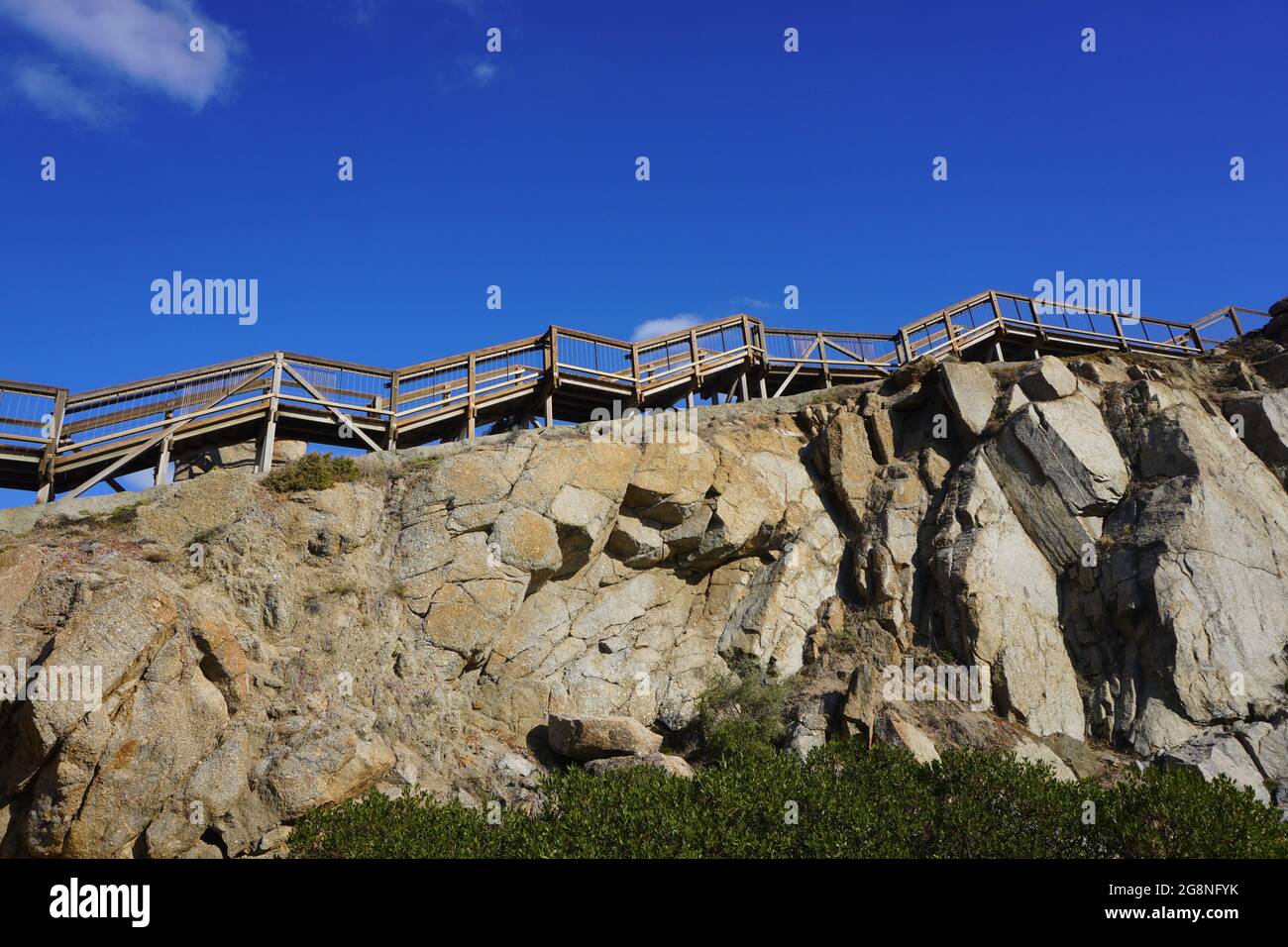 Low Angle Side View of wooden Zigzag Stairway over Rocks against Blue ...