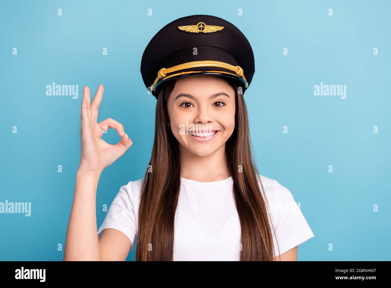 Portrait of attractive cheerful glad girl captain wearing hat howing ok ...