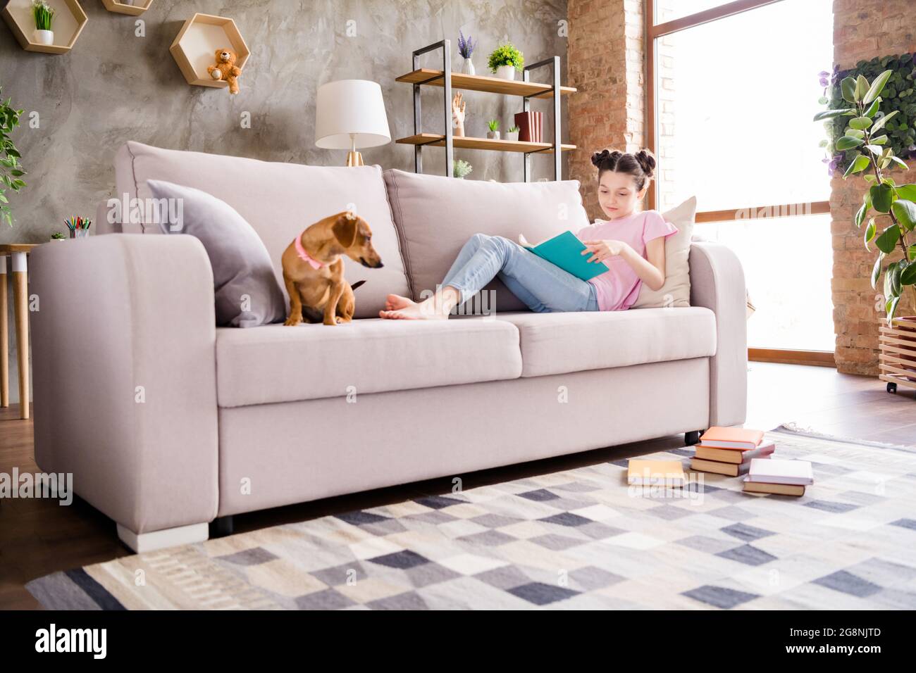 Portrait of attractive preteen girl reading book learning staying alone ...