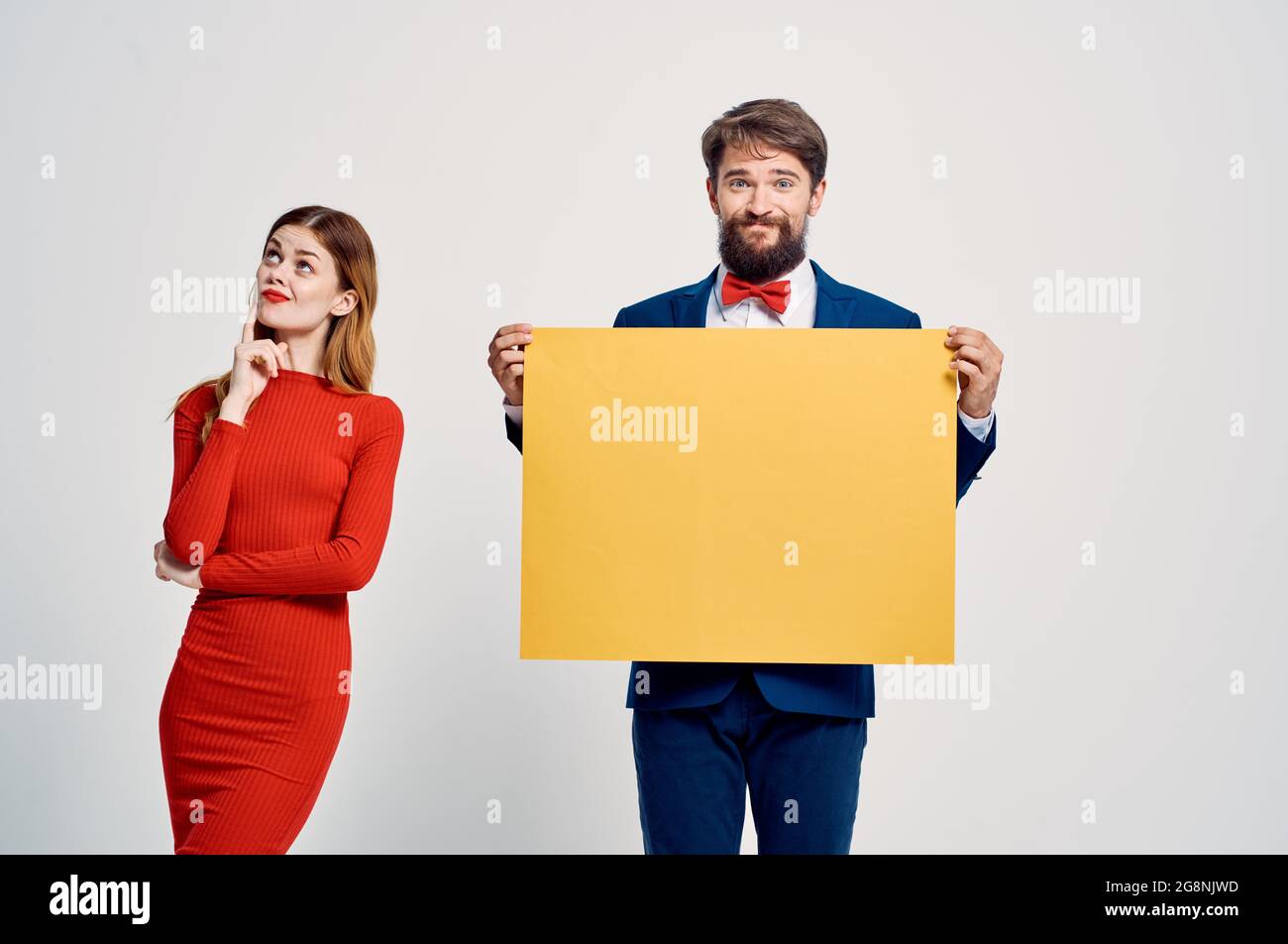 man and woman standing side by side advertising yellow mockup poster ...