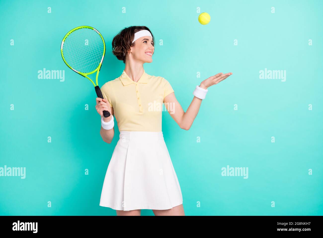 Photo of nice happy cheerful young woman look fall catch ball racket ...