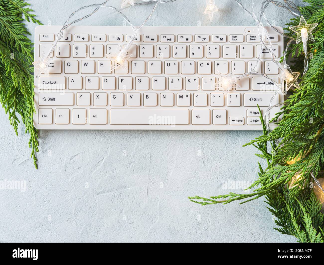 Workplace winter background with keyboard on gray background with green ...