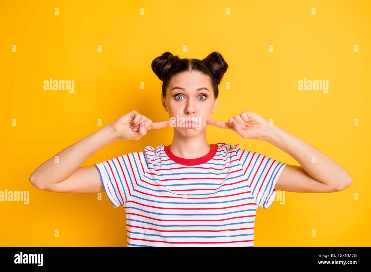 Photo of charming childish young girl dressed striped t-shirt finger ...