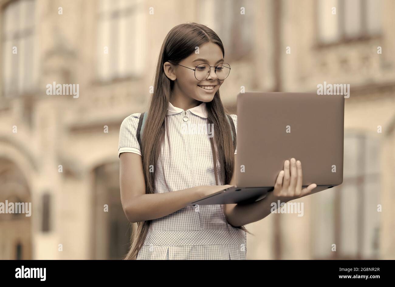 smart looking kid in gasses typing on computer searching information in ...