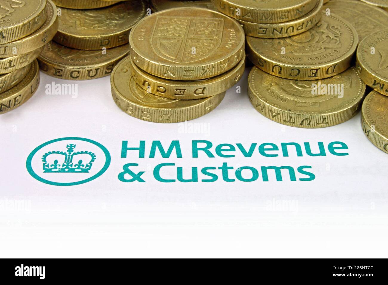 HM Revenue & Customs Tax Return with Pound coins Stock Photo - Alamy