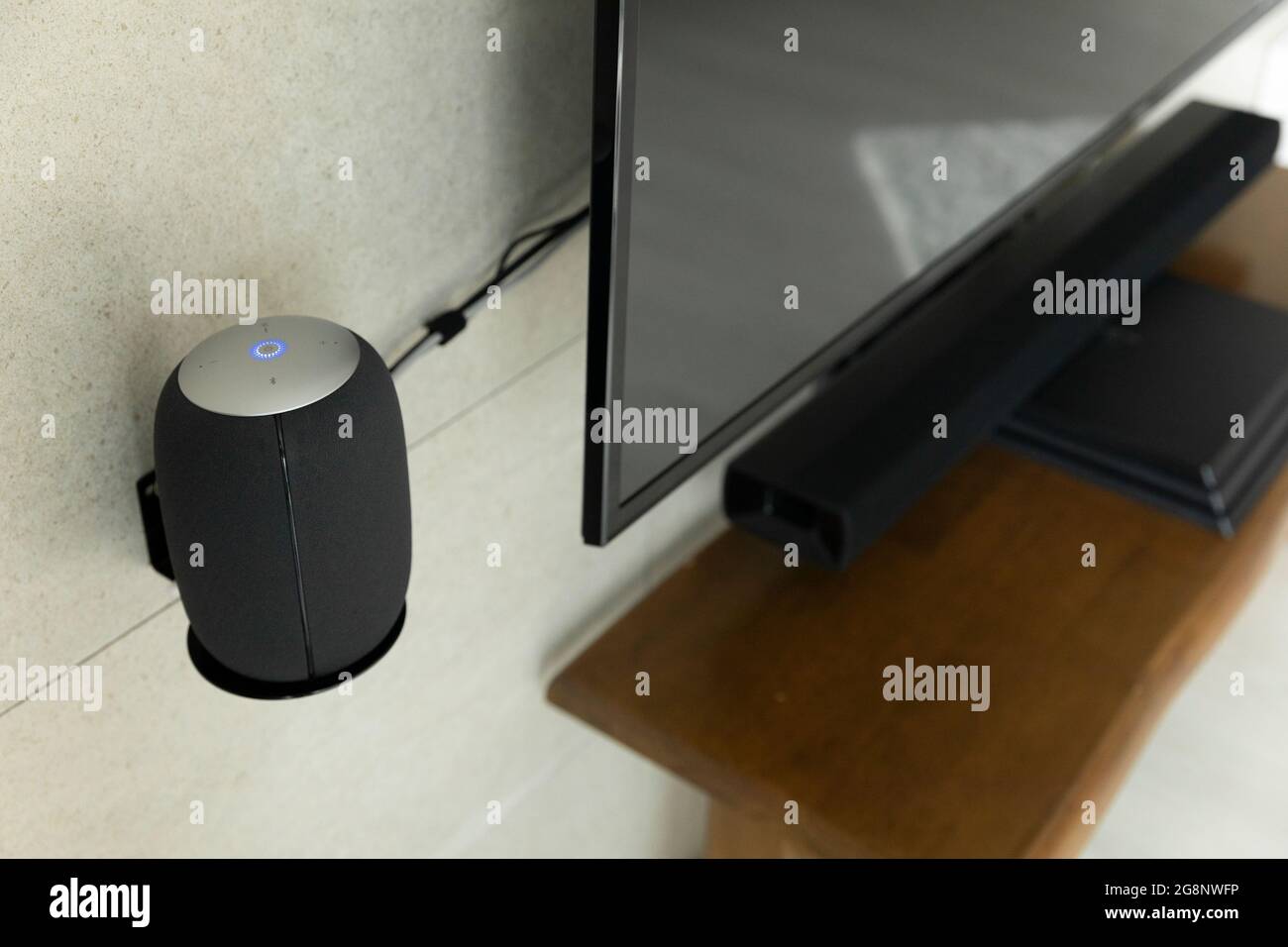 installing artificial intelligence speaker beside television Stock ... installing artificial intelligence speaker beside television Stock ...