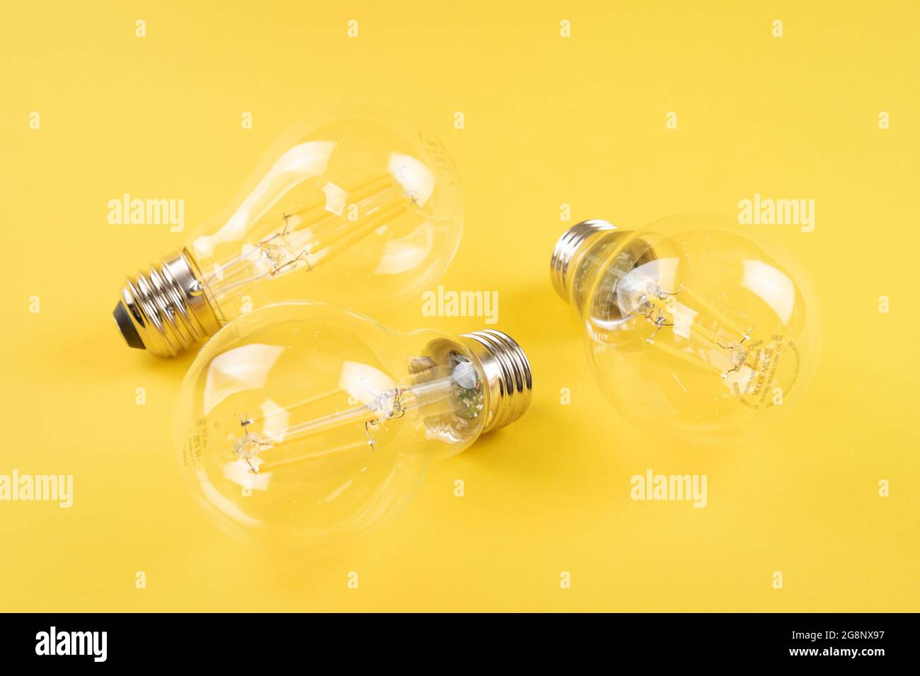 Transparent bulbs on yellow background Stock Photo - Alamy