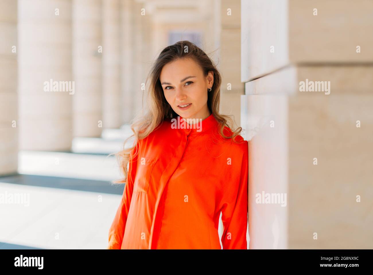 Beautiful girl model posing at the camera in the city in the shadow of ...