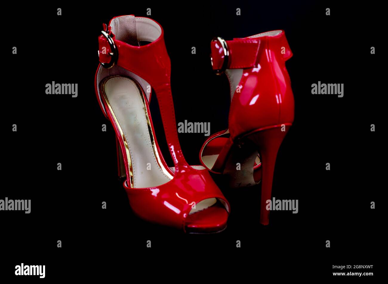 red patent leather sandal for the summer season on a black background ...