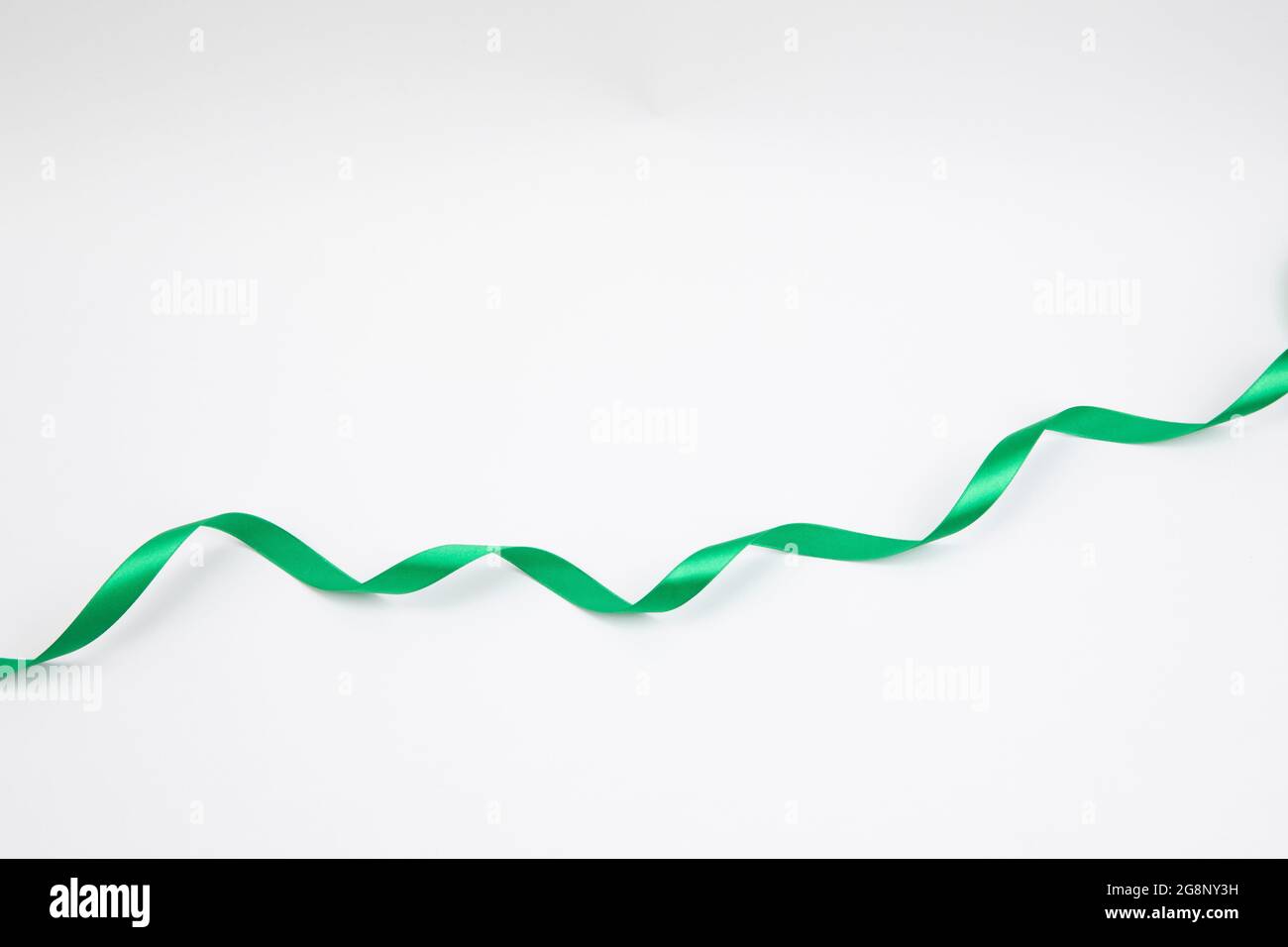 long green ribbon, white background Stock Photo - Alamy