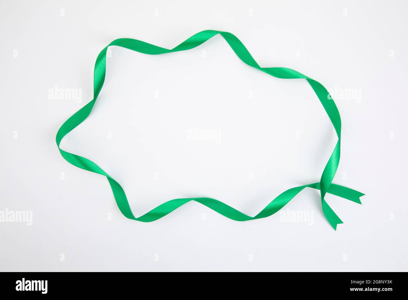 long green ribbon in circle, white background Stock Photo - Alamy