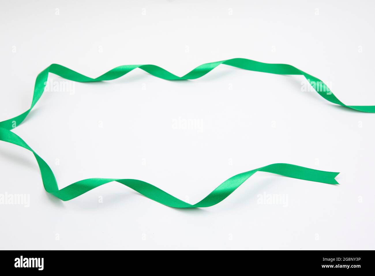 long green ribbon, white background Stock Photo - Alamy