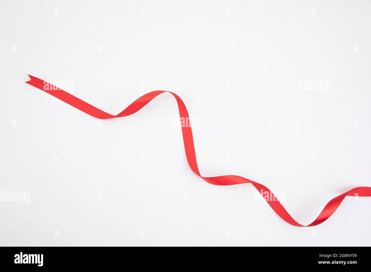long red ribbon, white background Stock Photo - Alamy