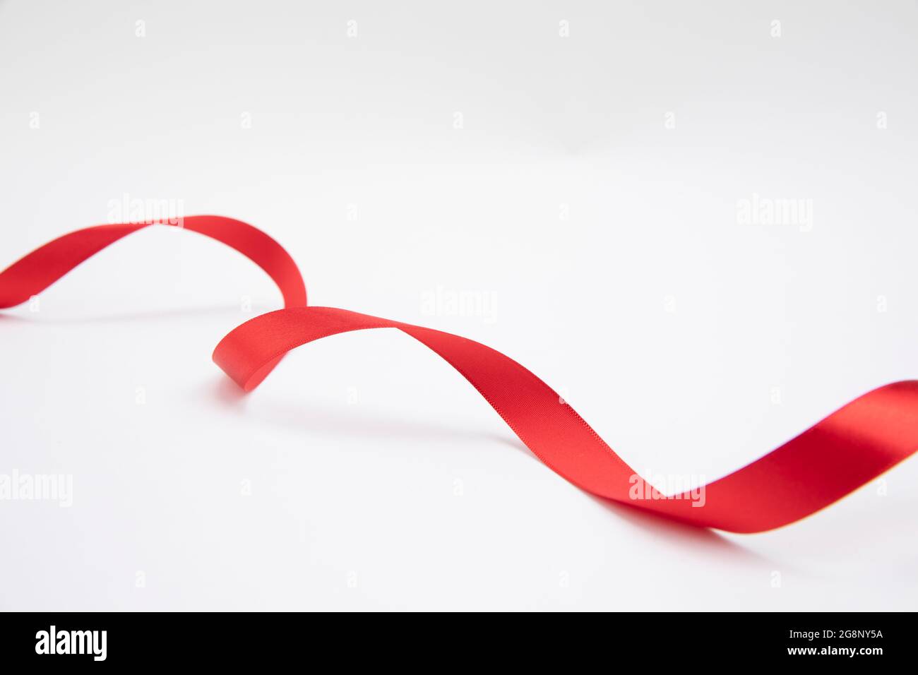 long red ribbon, white background Stock Photo - Alamy