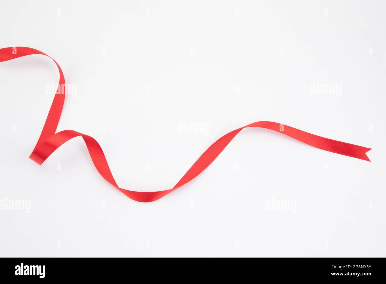 long red ribbon, white background Stock Photo - Alamy