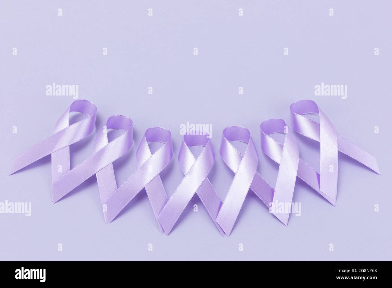 purple ribbons on purple background Stock Photo - Alamy