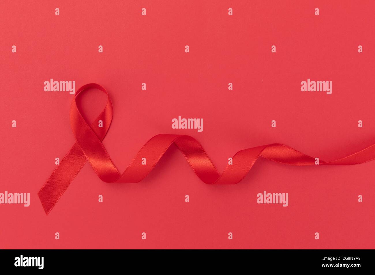 Red ribbon on red background Stock Photo - Alamy