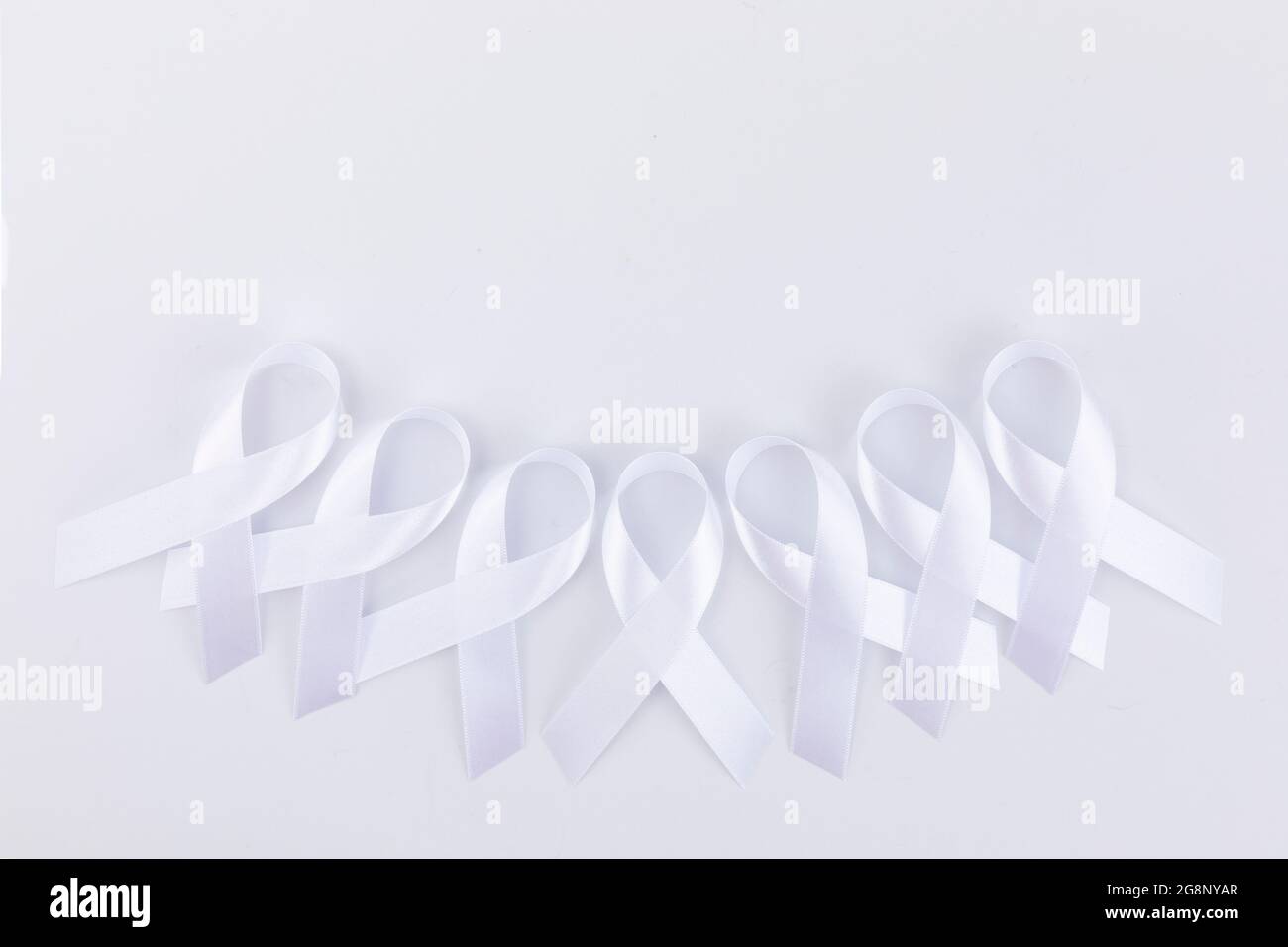 White ribbons on white background Stock Photo - Alamy