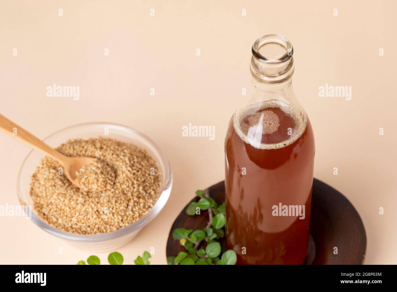 sesame seed in glass bowl with wood spoon and sesame oil bottle Stock ...
