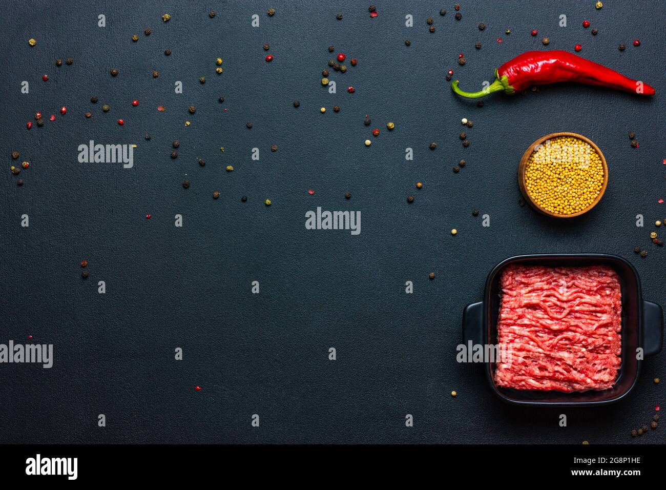 Culinary frame background in dark shades with minced meat, pepper ...