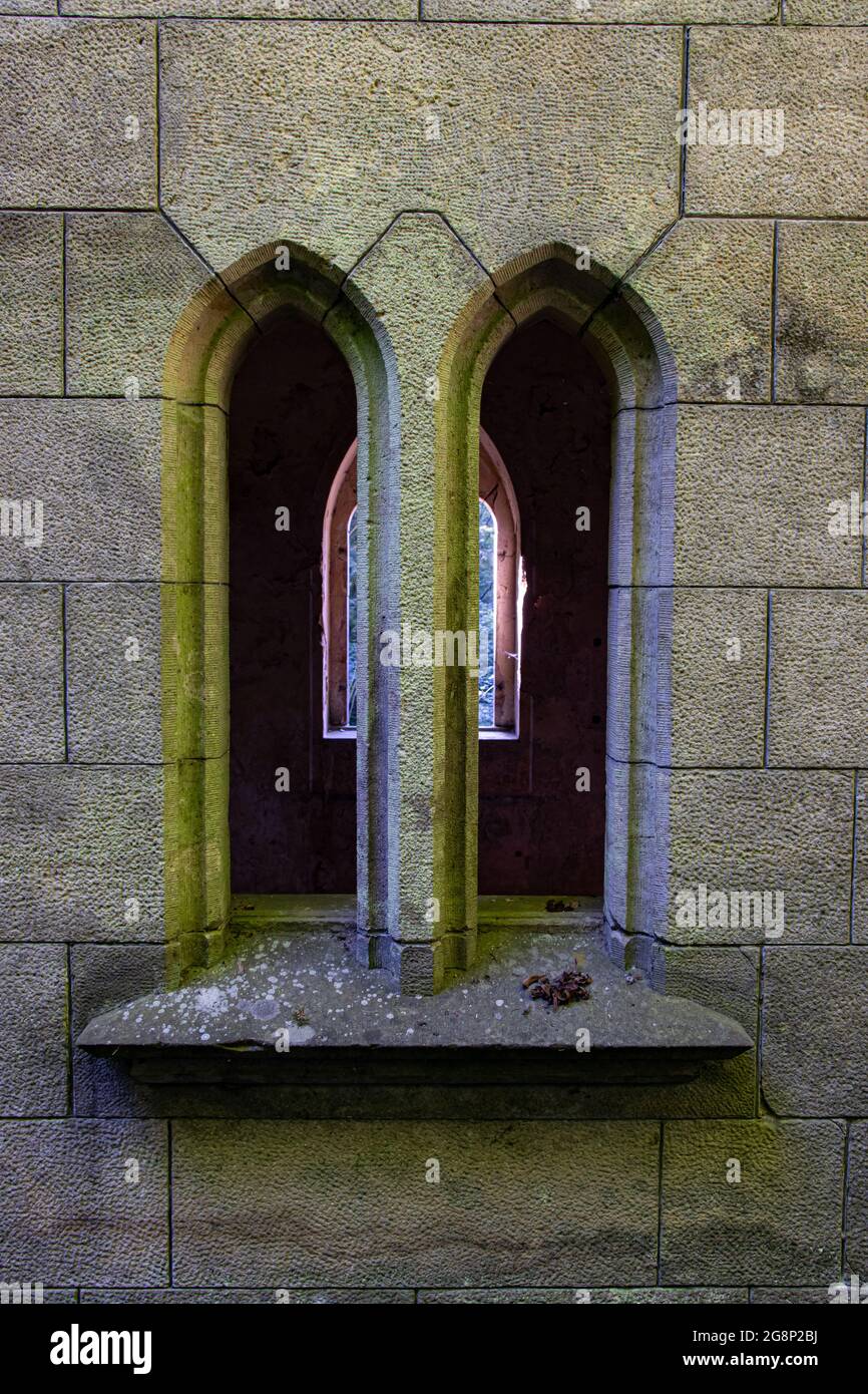 A windows at gothic chapel with a tomb in the defunct cemetery Stock ...