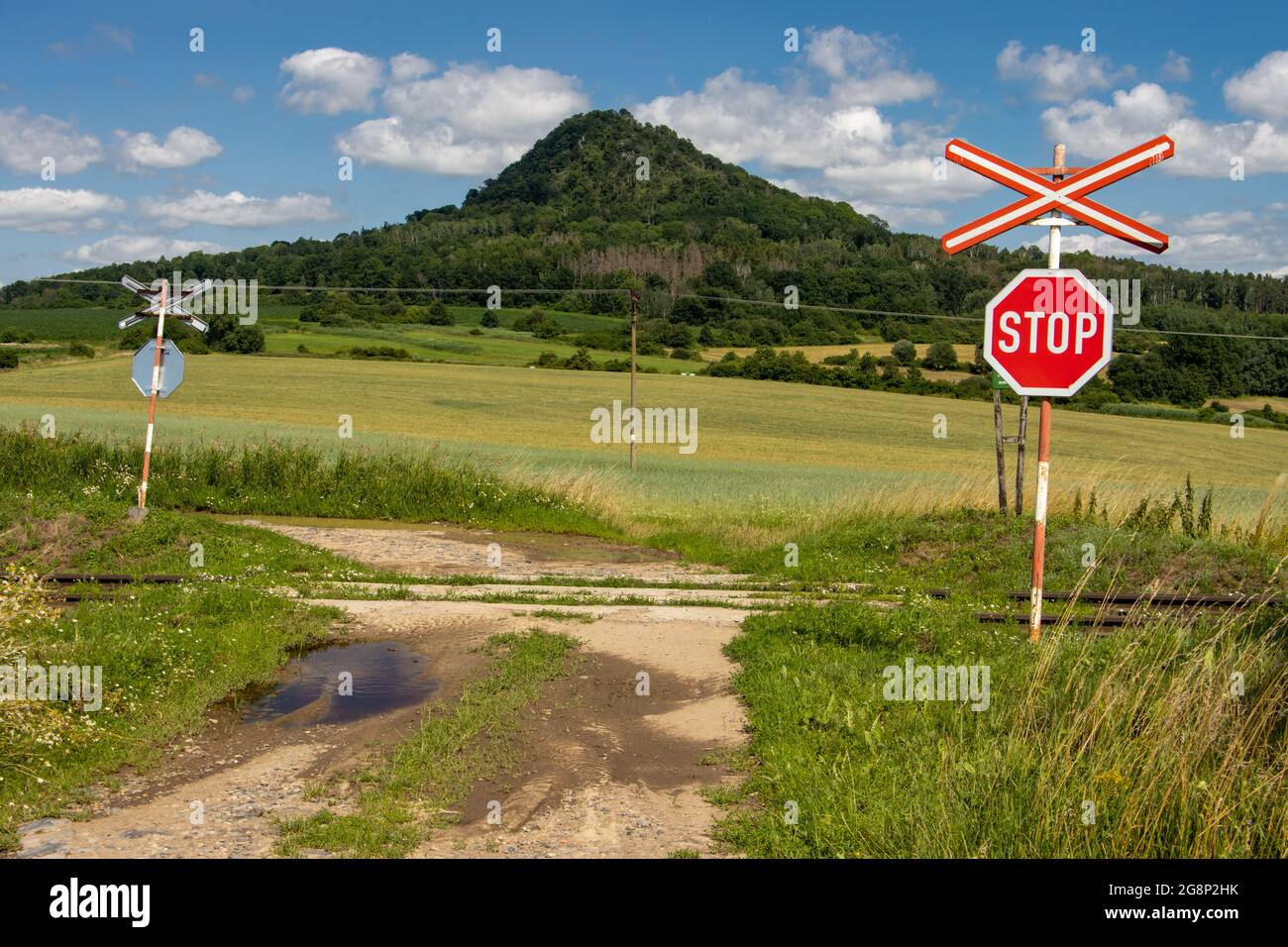 A red STOP sign before crossing the tracks, Czech Central Highlands ...