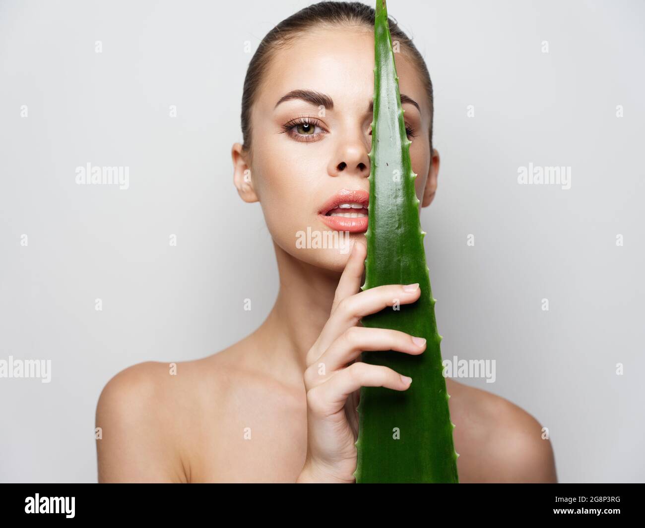 woman green aloe leaf light background clean skin cosmetology model ...