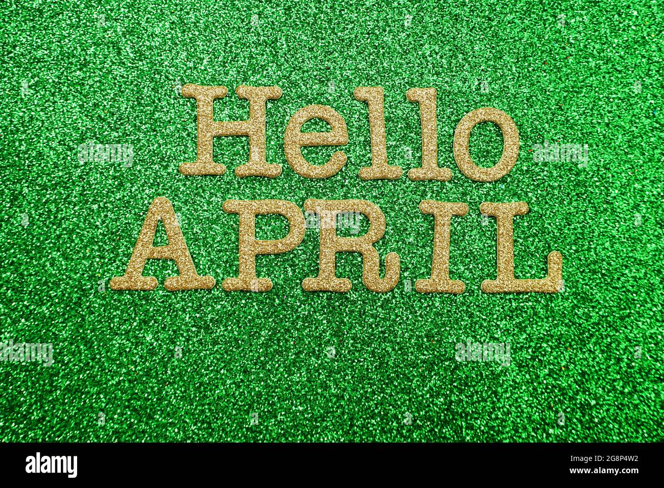 Hello April alphabet letters on green glitter background Stock Photo ...