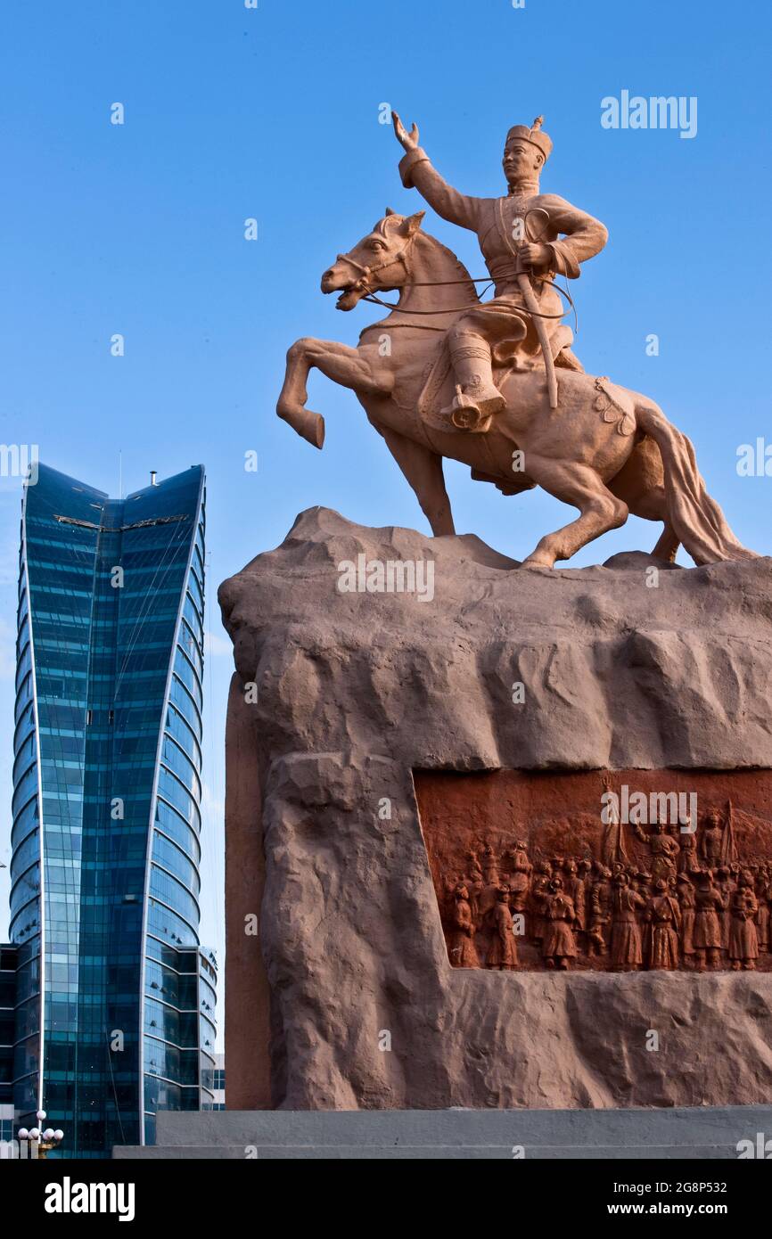 Statue of Sukhbaatar on horse, with new development behind, blue sky ...