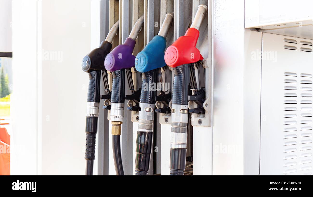 Fuel dispensing guns at a gas station for different types of gasoline ...