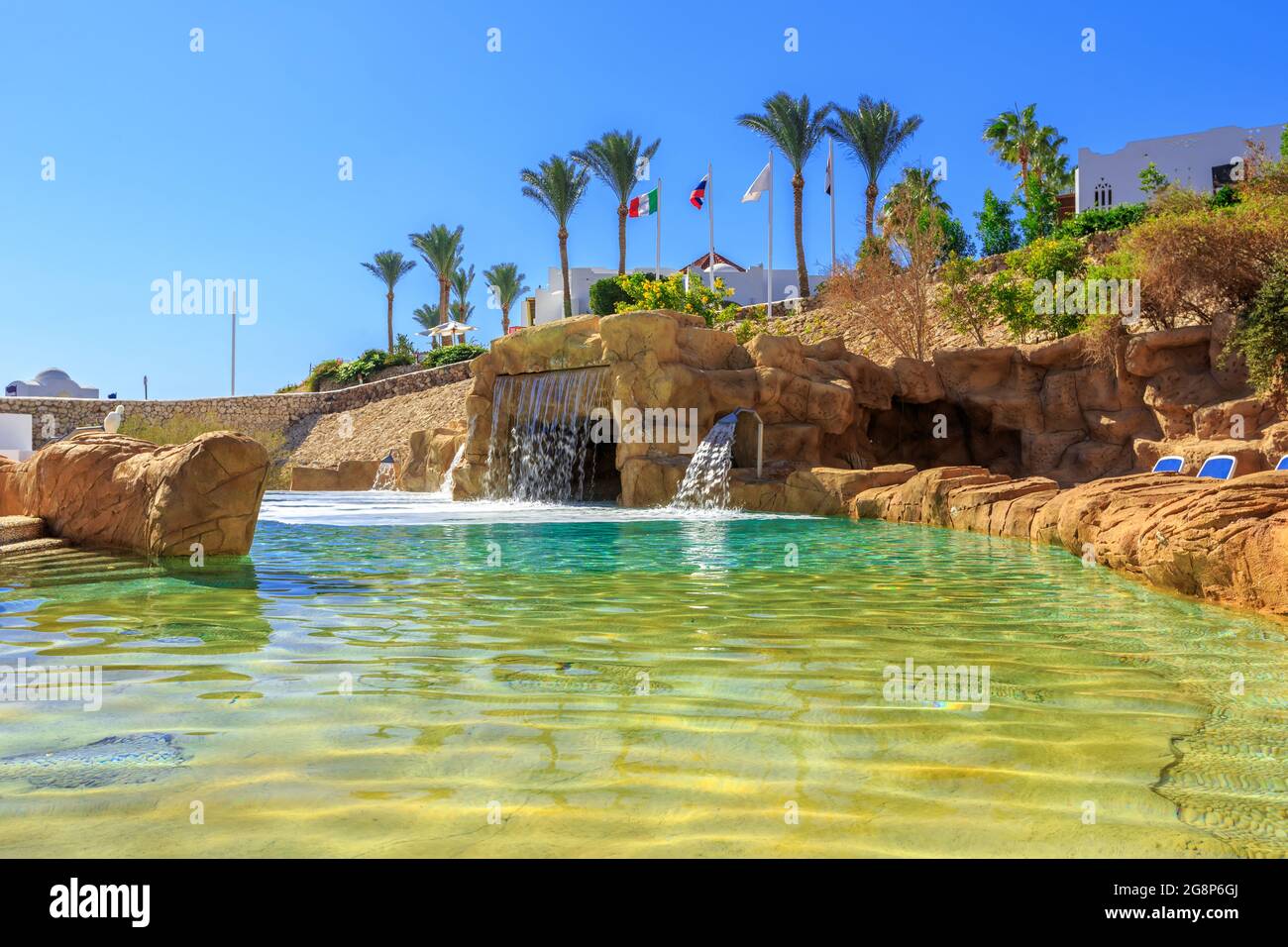 Beautiful swimming pool and palm trees in Egypt Stock Photo - Alamy