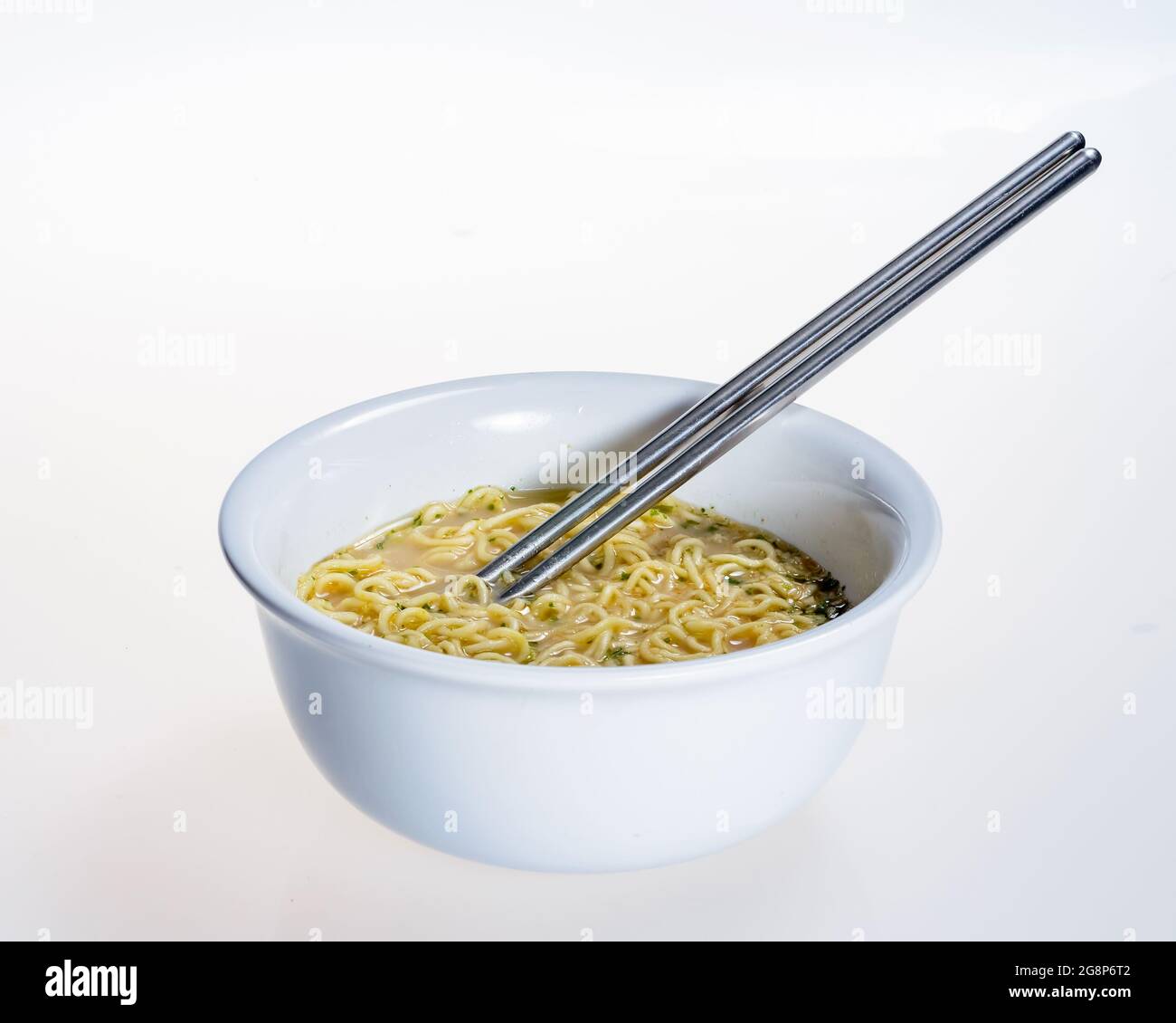 ready to eat cooked instant noodles in white bowl and stainless steel ...