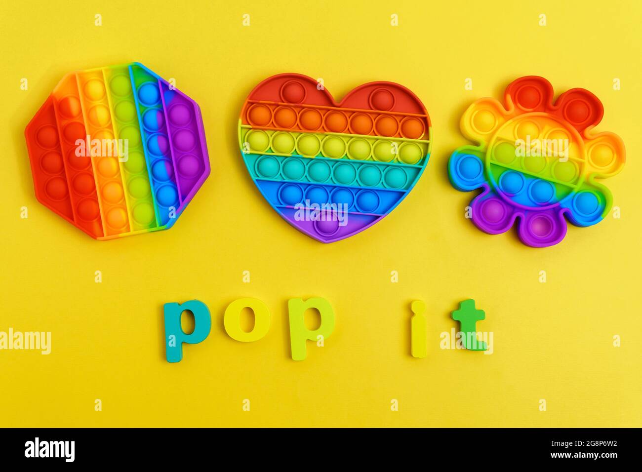 Pop it fidget sensory toy on a yellow background. Top view Stock Photo ...