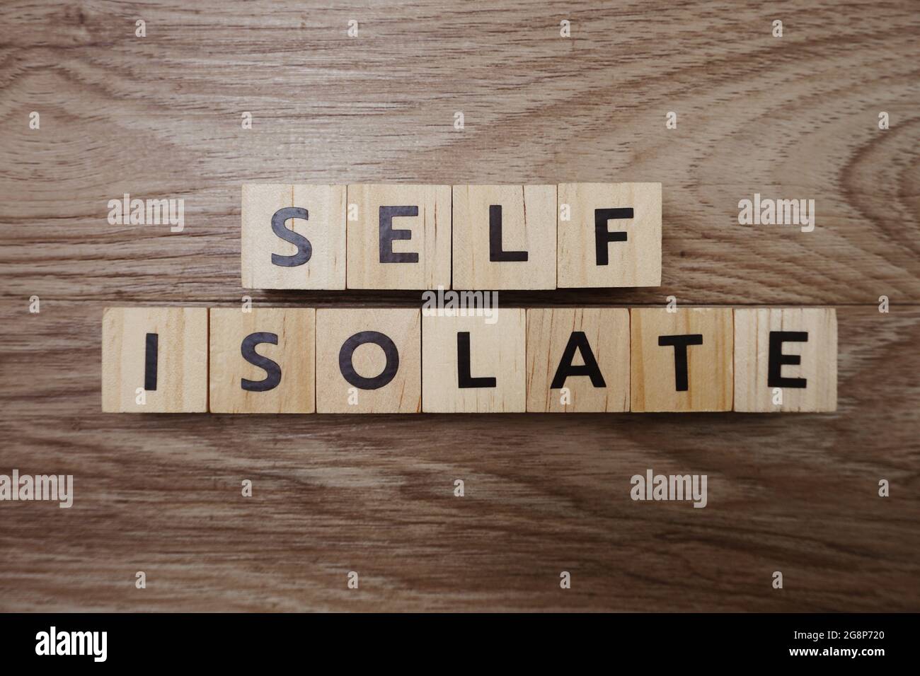 Self Isolate alphabet letters on wooden background Stock Photo - Alamy