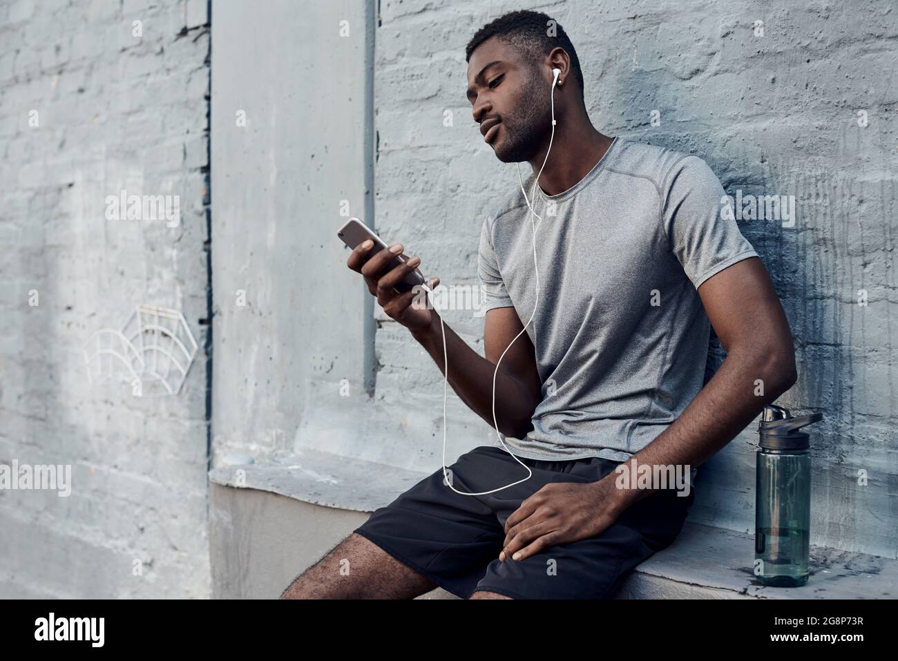 He has multiple fitness apps to keep him at it Stock Photo - Alamy