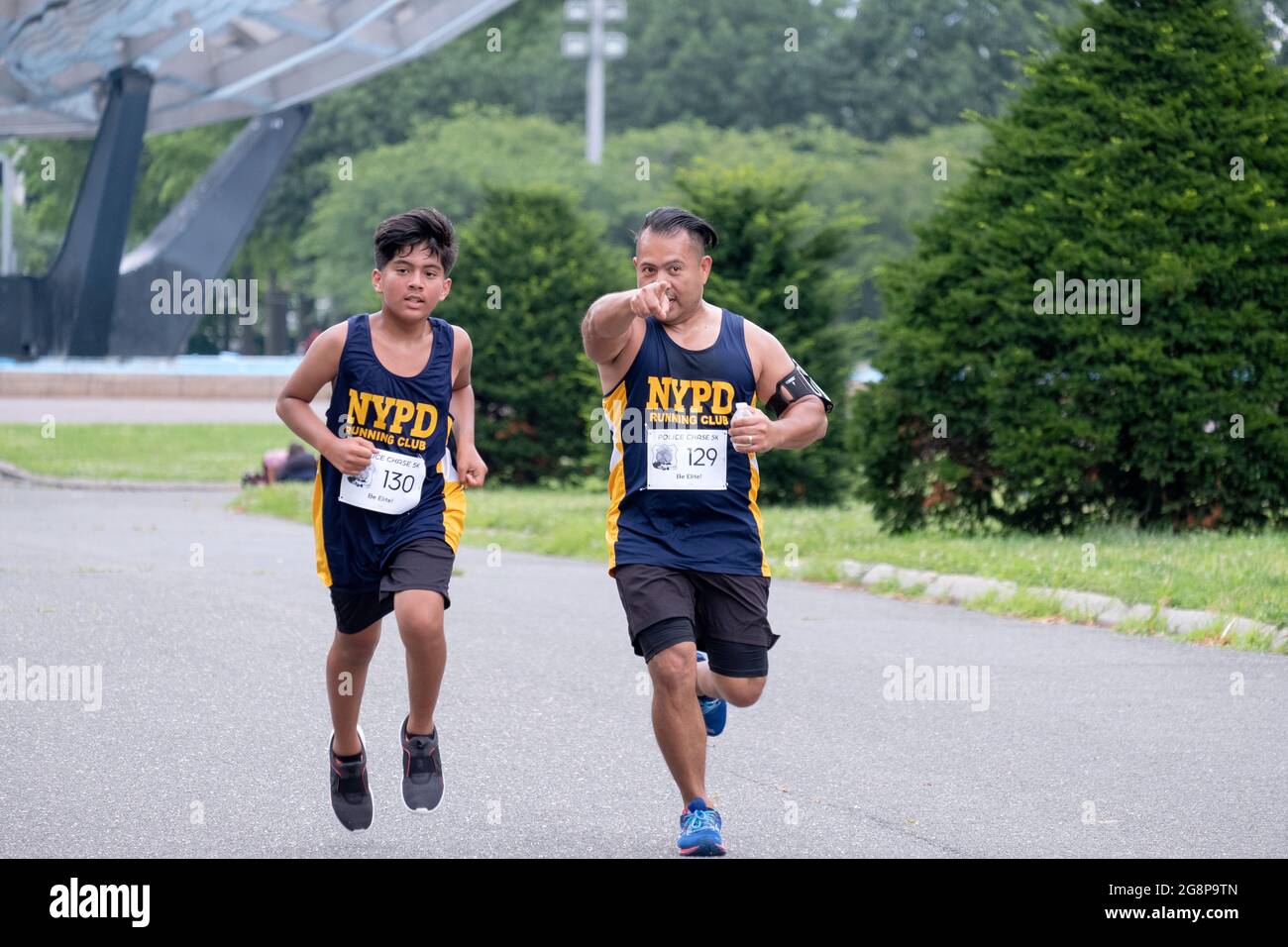 A father encourages his son near the finish line at the Police Chase 5k ...