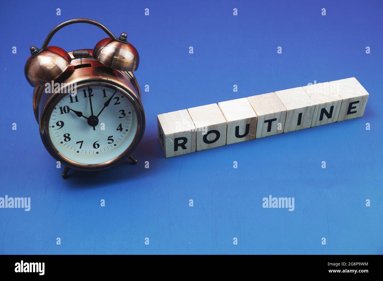 Routine alphabet letters and alarm clock on blue background Stock Photo ...