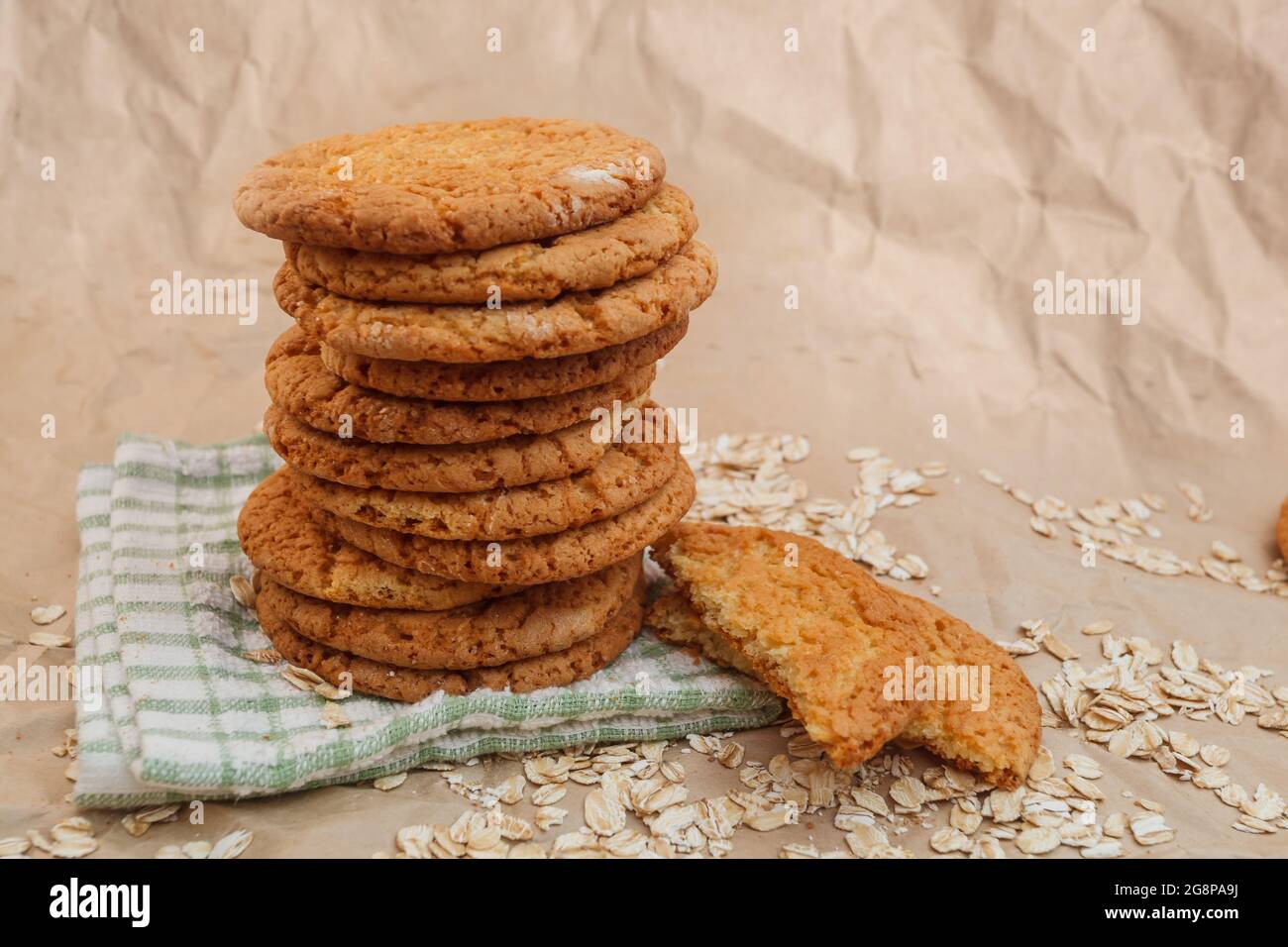 oatmeal cookies and scattered oatmeal on crumpled paper background ...