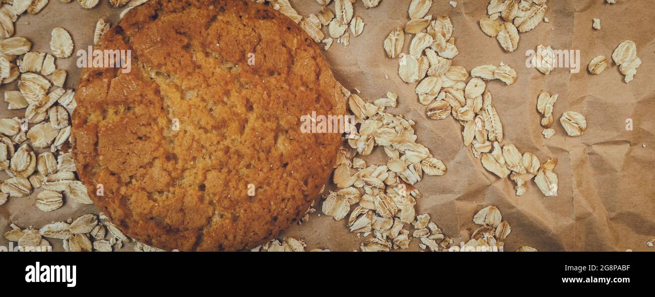oatmeal cookies and oat flakes scattered on panaramnom background ...