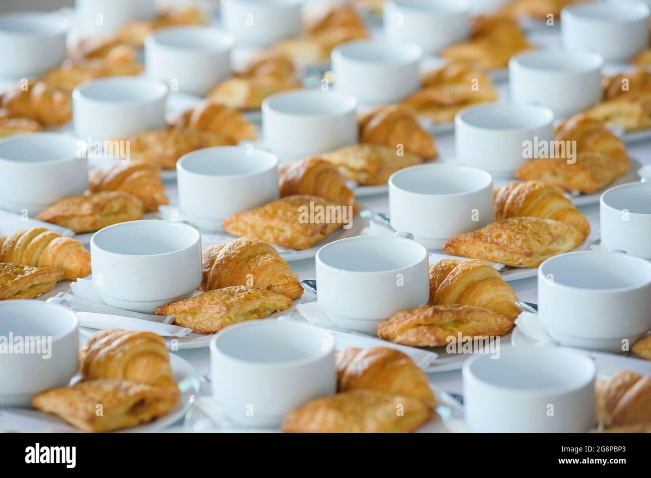 line of croissant waiting for coffee break Stock Photo - Alamy