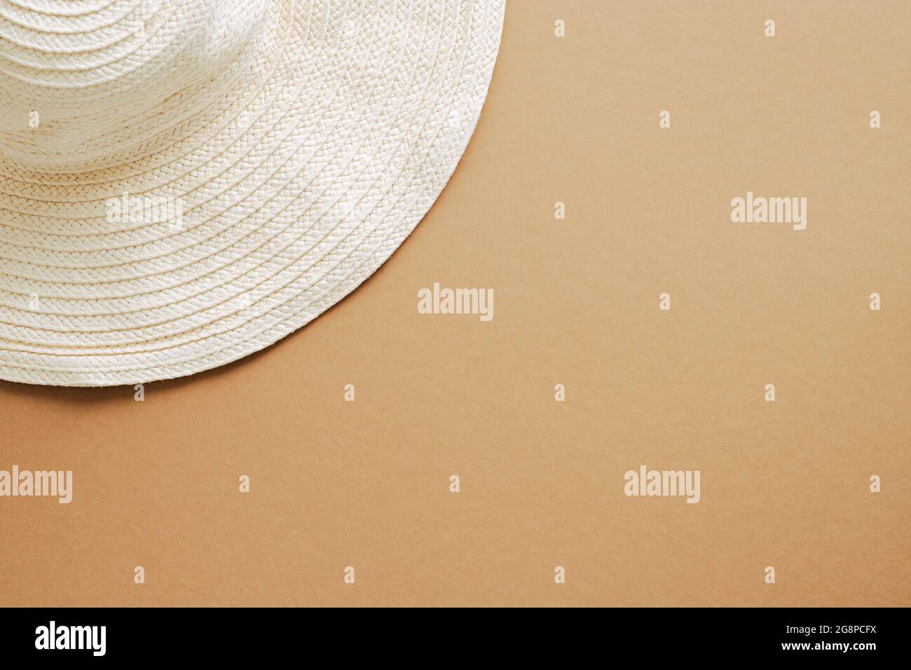 Flat lay straw hat on sandy color background. Top view, overhead ...