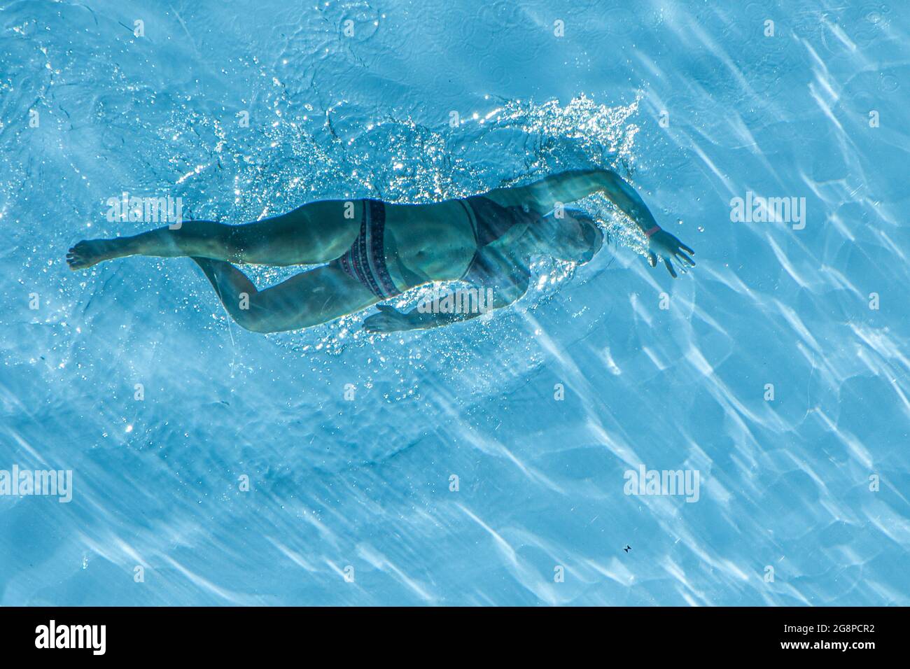 VAUXHALL LONDON 22 July 2021 . A swimmer cooling off at the 25 m long ...