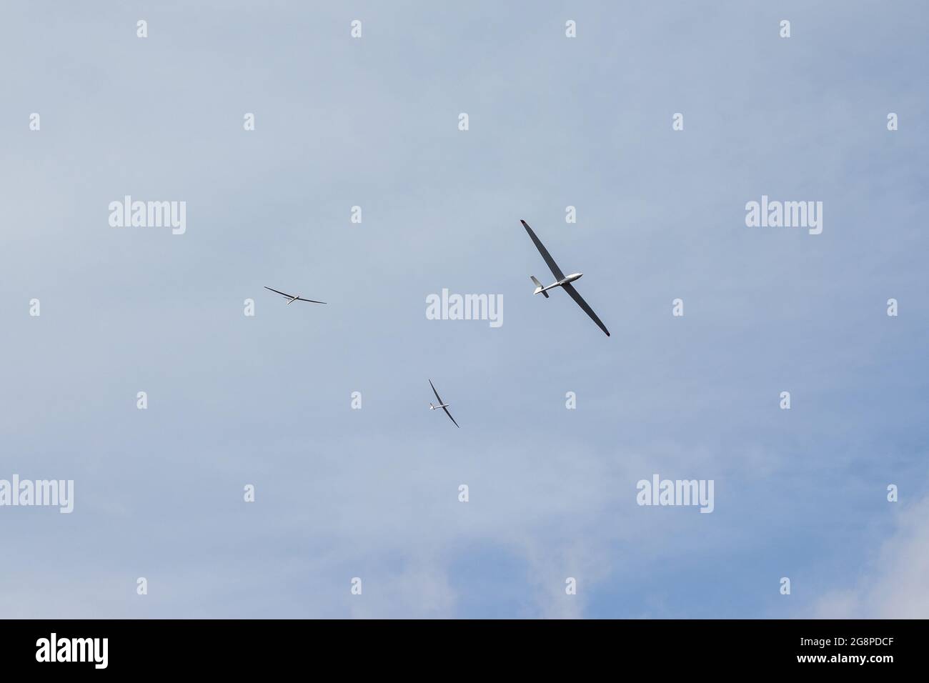Group of three gliders flying against cloudy sky. High performance ...