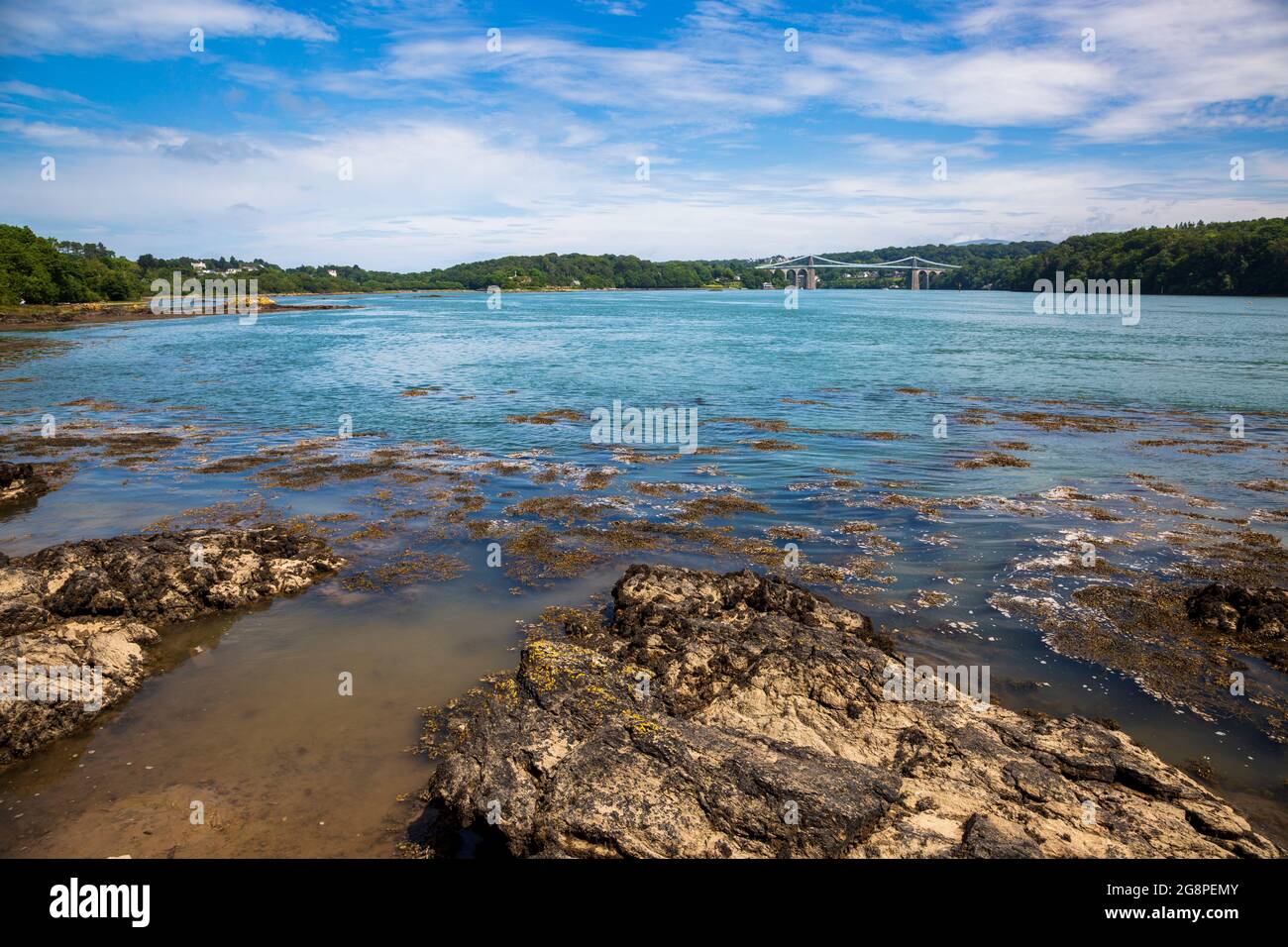 The Menai Strait at high-tide with Menai Suspension Bridge in the ...