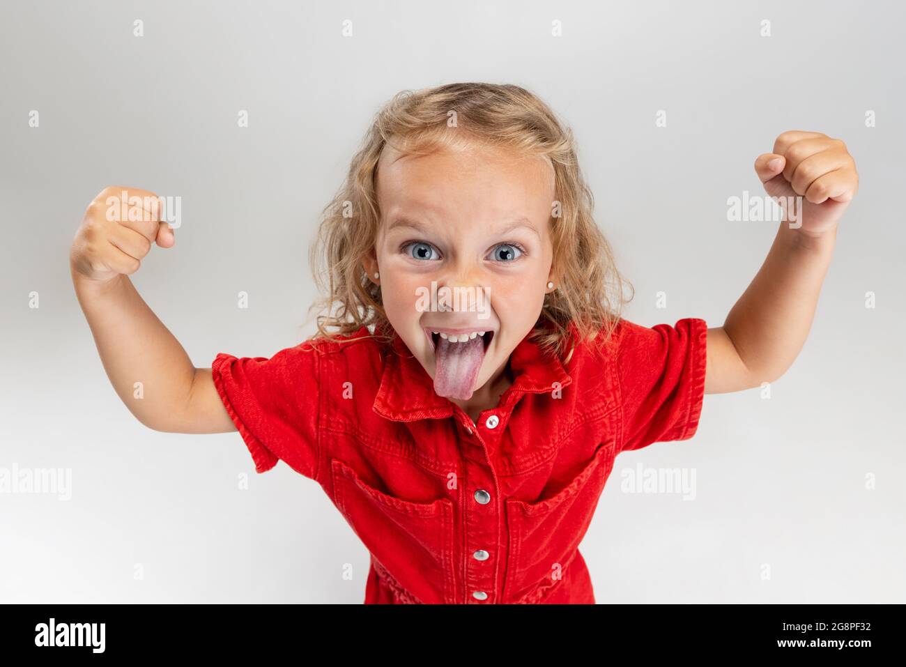 Half length portrait of little blonde preschool girl posing isolated ...