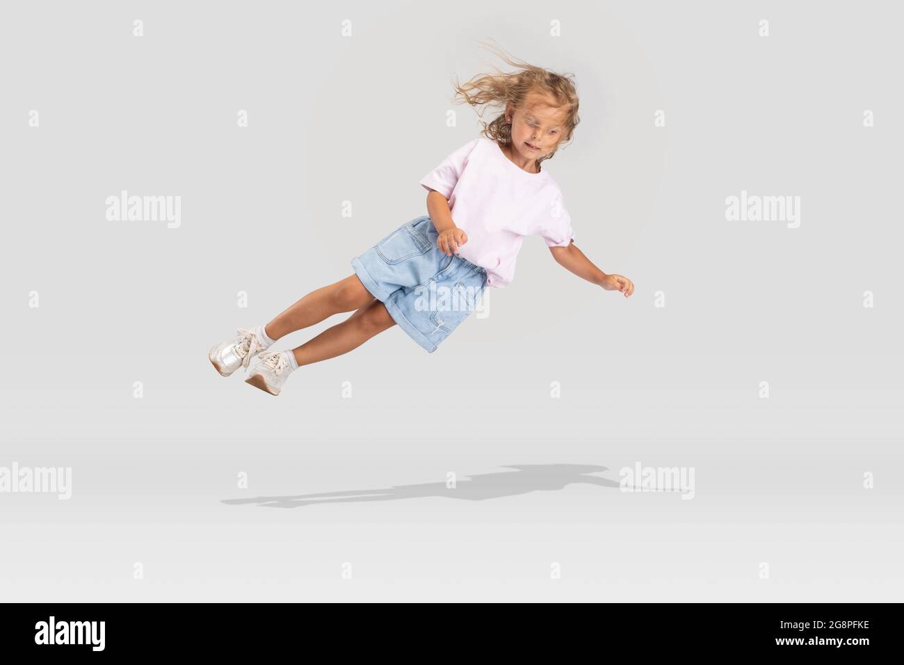 Studio shot of little preschool Caucasian girl in casual clothes ...