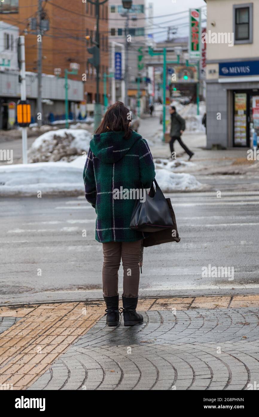 Otaru, Japan - December 25, 2017: Unidentified pedestrians walk in ...